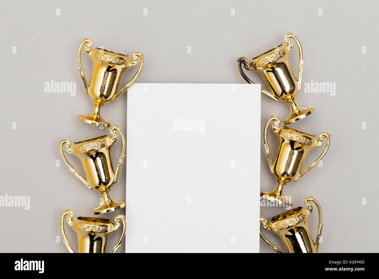 Gold winners trophy with blank certificate Stock Photo - Alamy