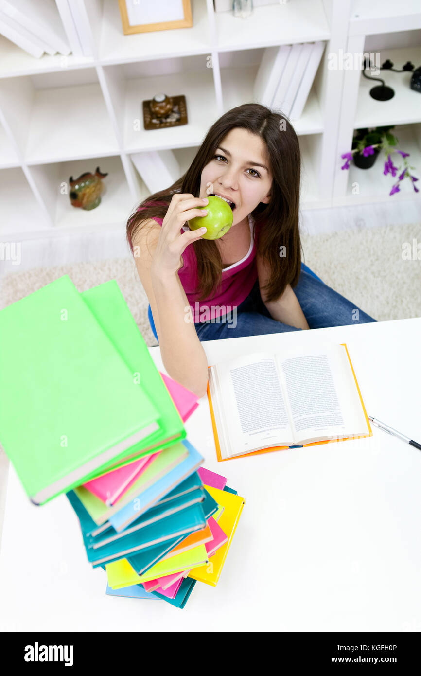 Teenager girl having break for snack Stock Photo - Alamy