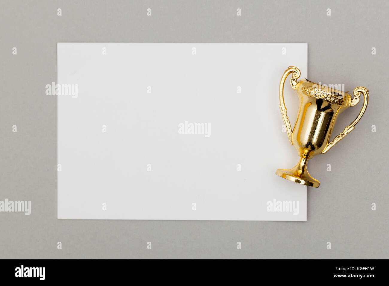 Gold winners trophy with blank certificate Stock Photo - Alamy