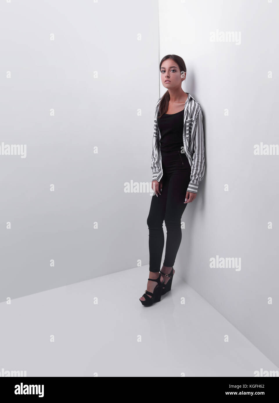 young woman leaning on wall Stock Photo - Alamy