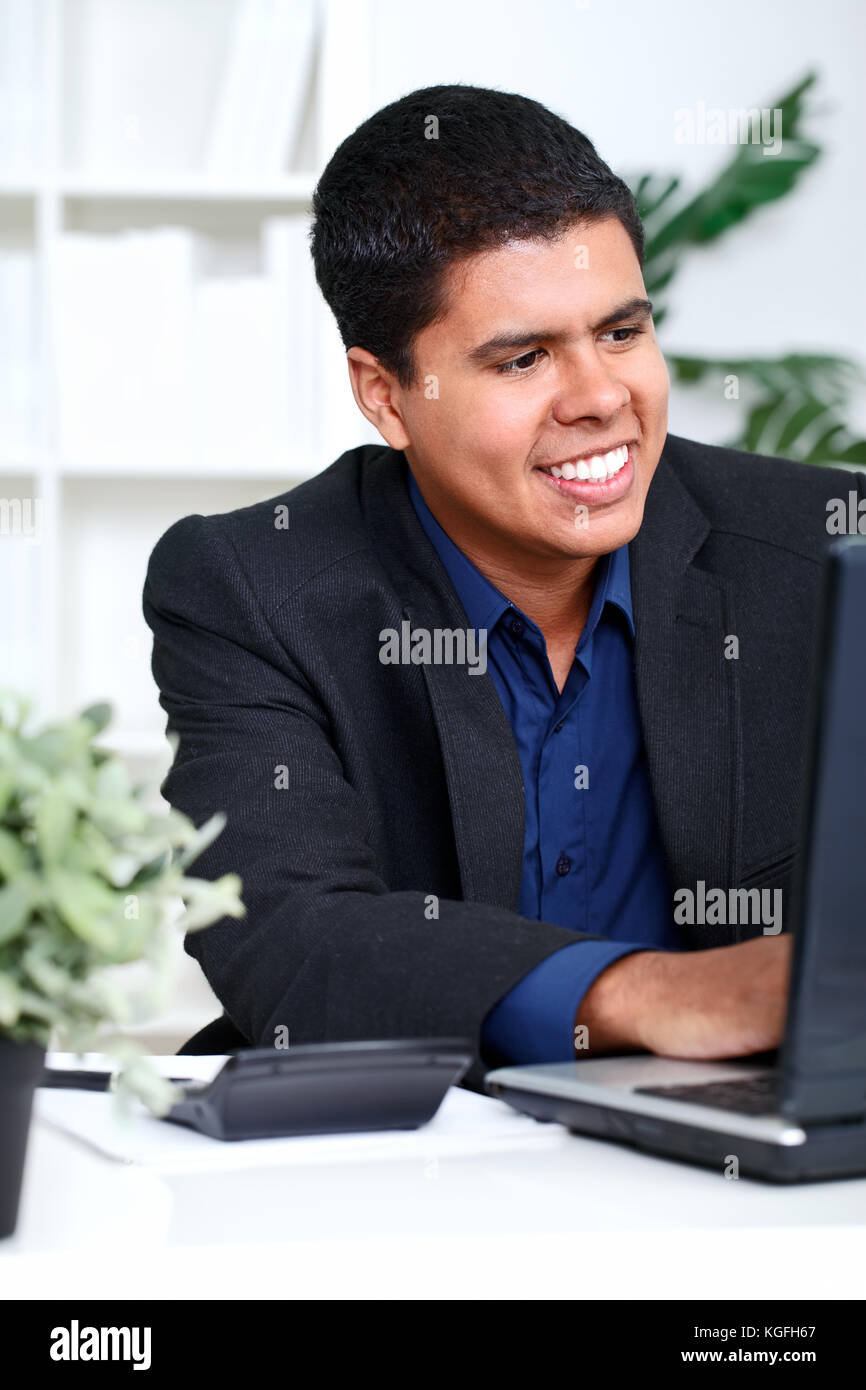 Smiling business man executive using a computer in his office Stock ...