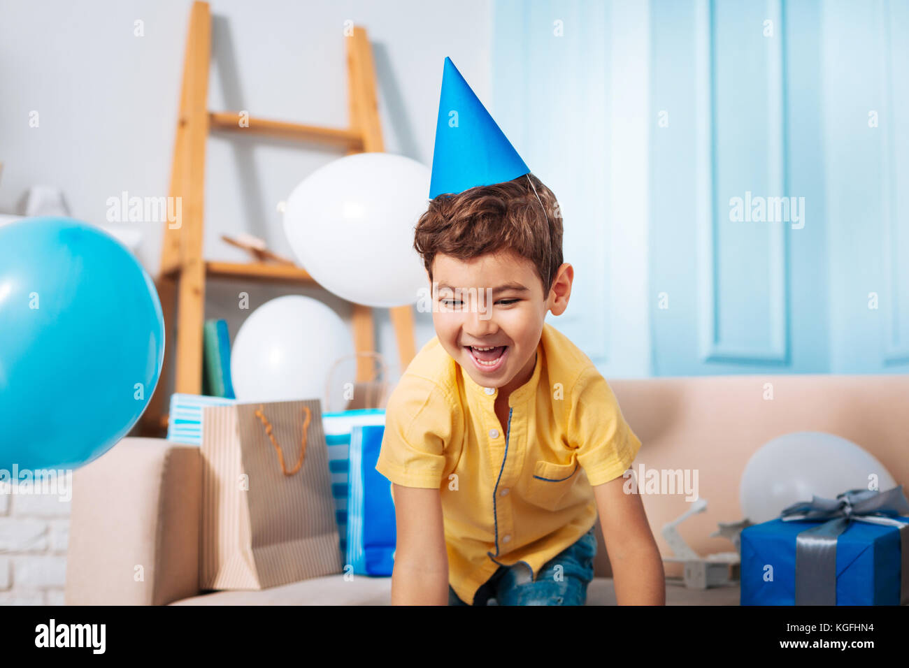 Happy little boy in party hat having fun Stock Photo - Alamy
