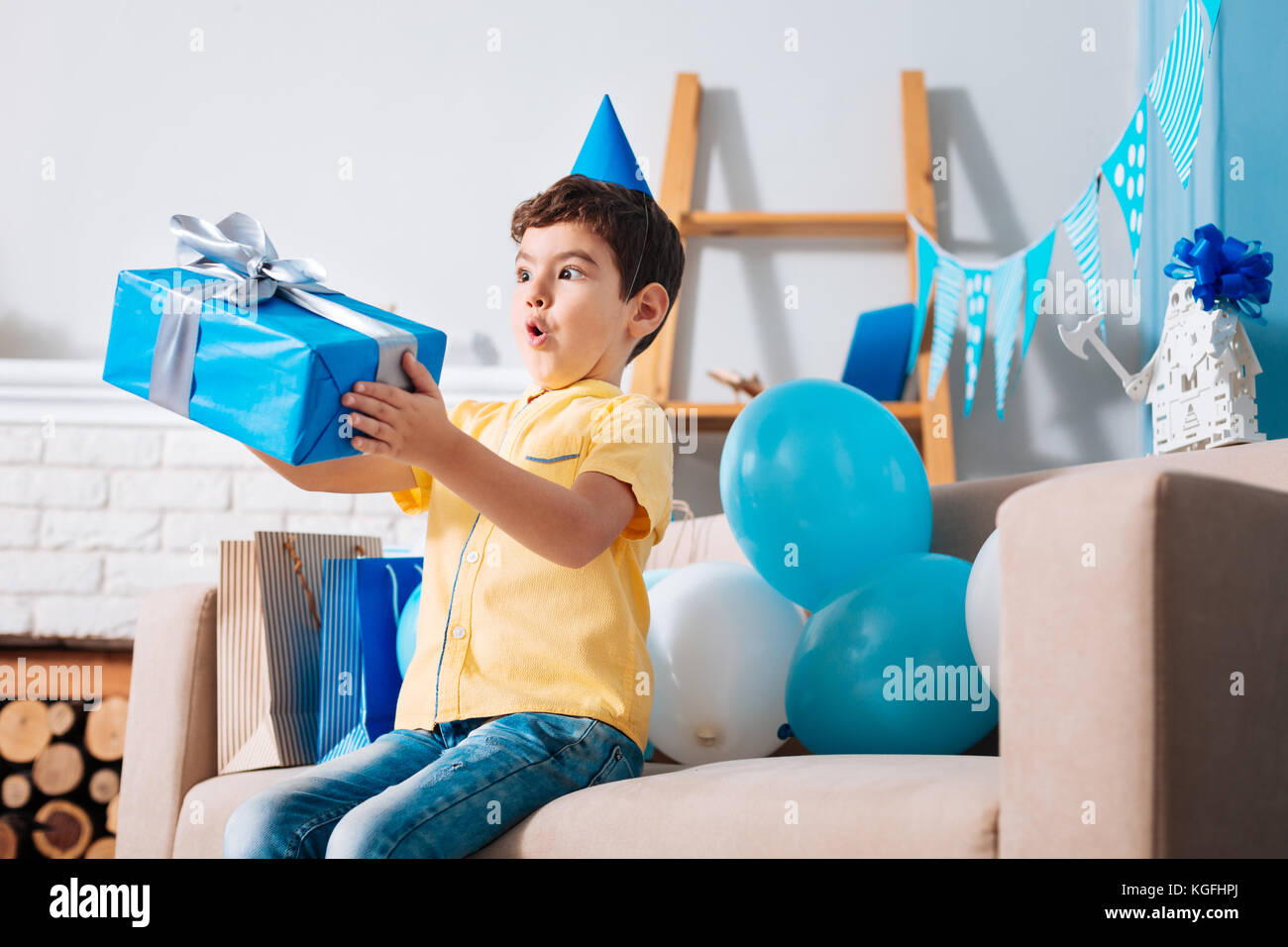 Little boy being surprised by his birthday present Stock Photo - Alamy