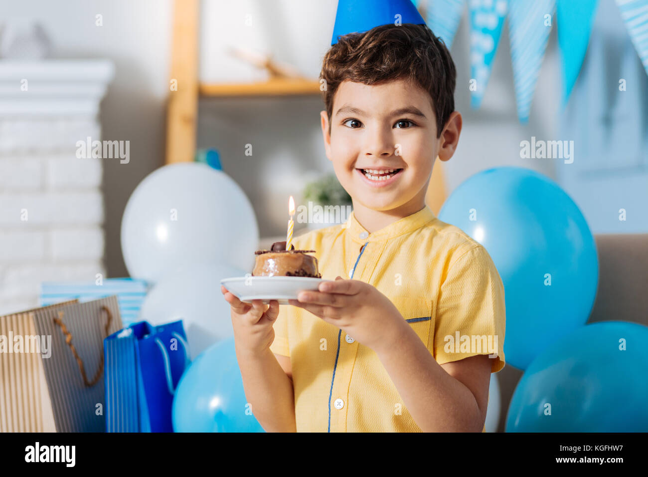 Happy boy celebrating his birthday with a cake Stock Photo - Alamy