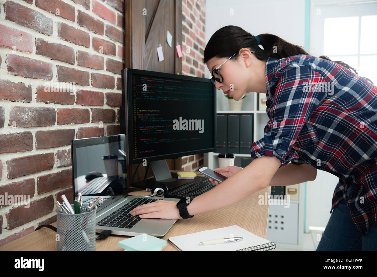 Elegant employee holding smartphone standing hi-res stock photography ...