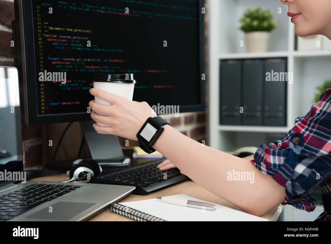 smiling attractive female programmer wearing smartwatch with blank ...