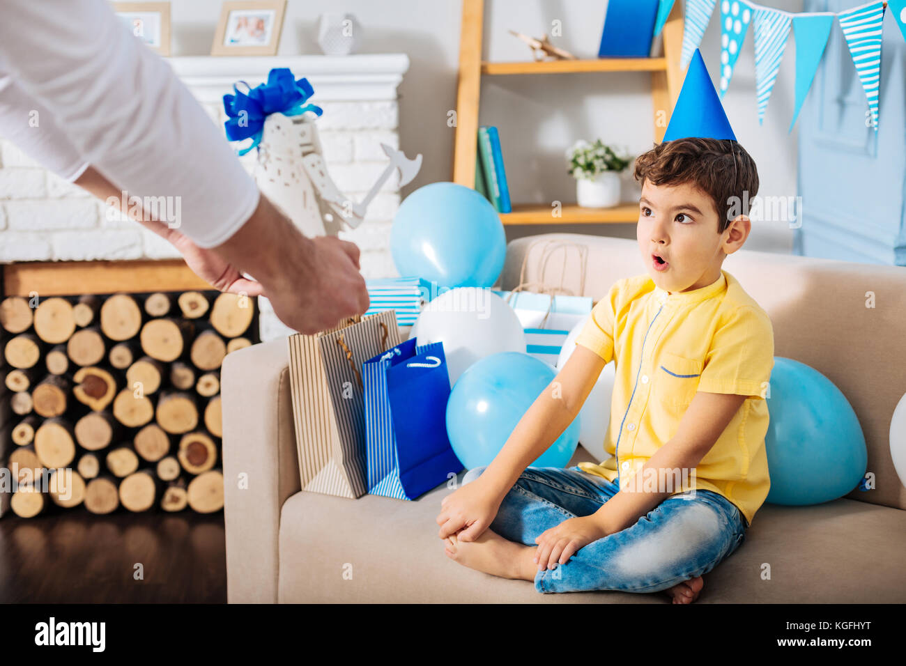 Surprised boy looking at father giving him toy robot Stock Photo - Alamy