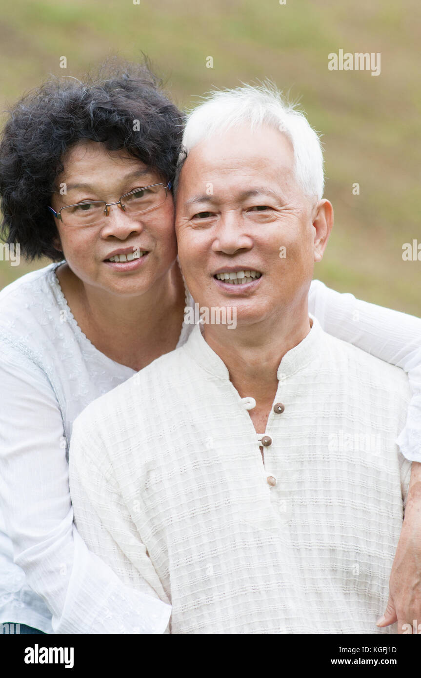 Portrait of elderly Asian couple relaxing at outdoor park Stock Photo ...