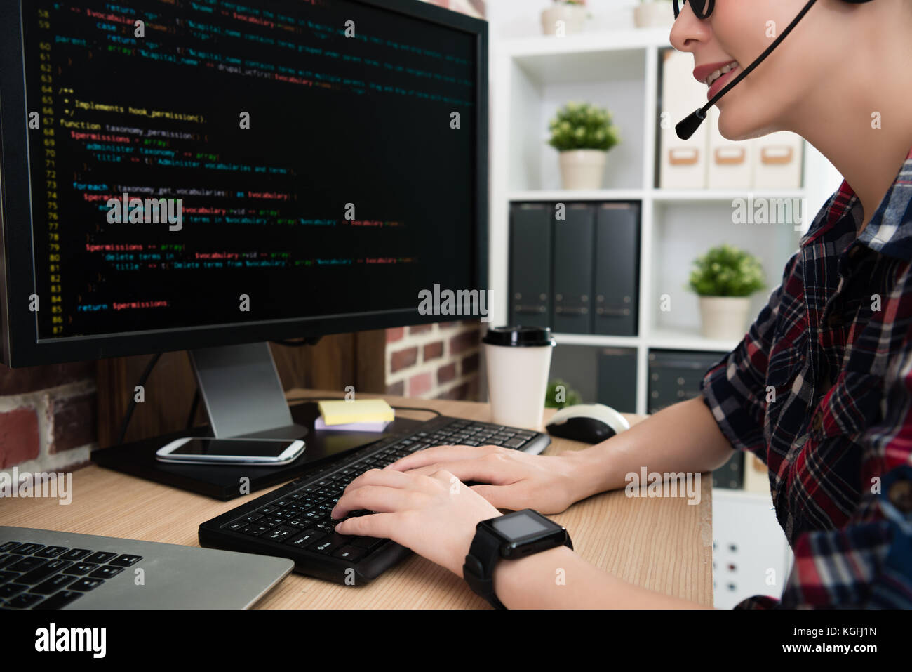 friendly smiling female operator working on programming company and ...