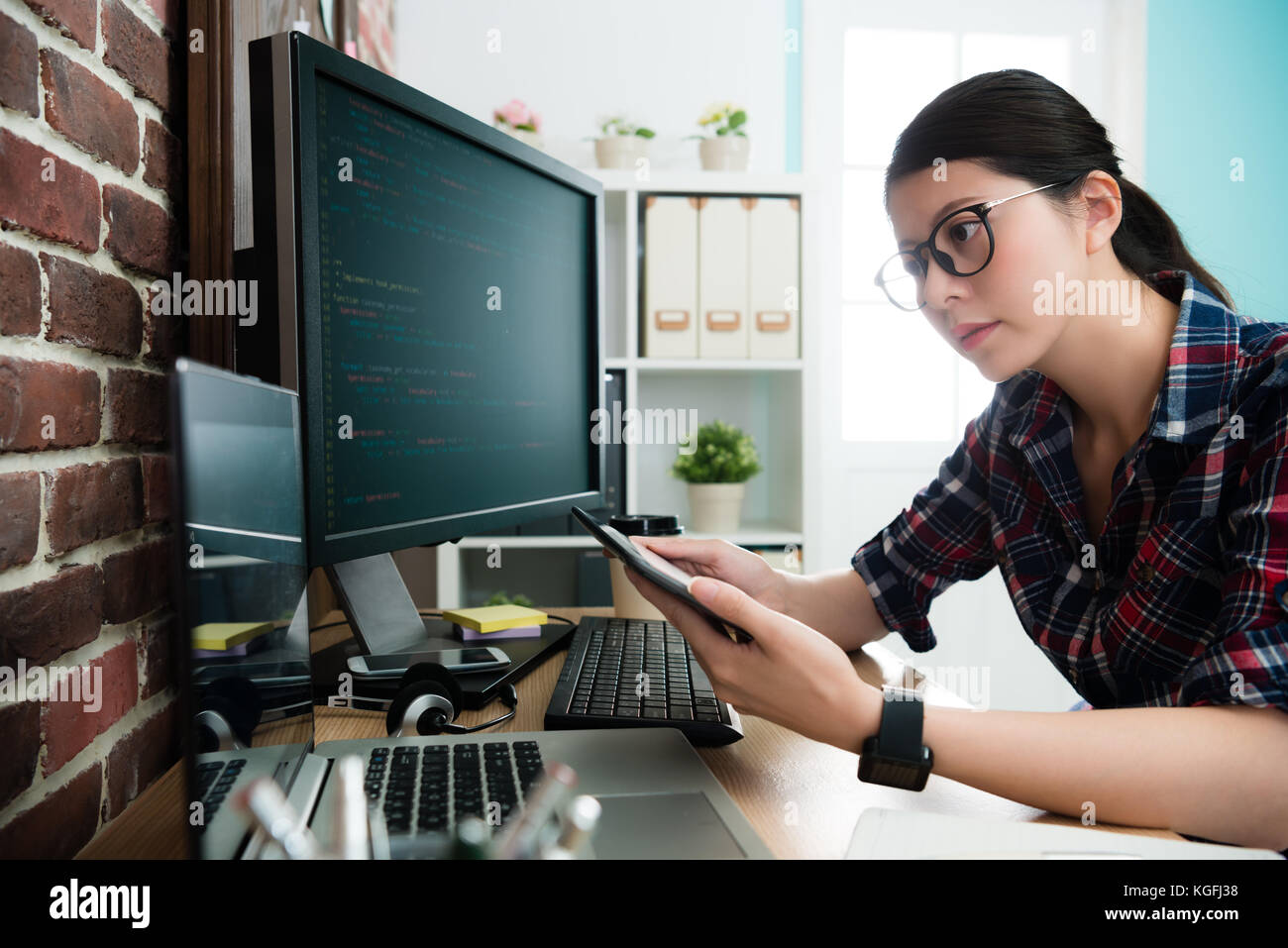 elegant attractive female programmer using mobile pad computer working ...