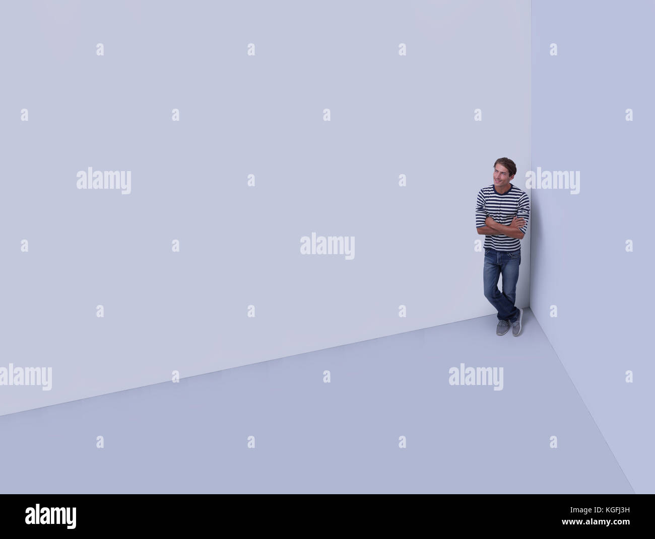 thoughtful man standing in the corner Stock Photo - Alamy