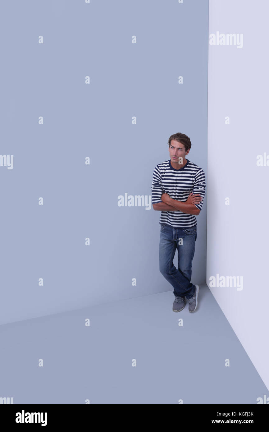 thoughtful man standing in the corner Stock Photo - Alamy