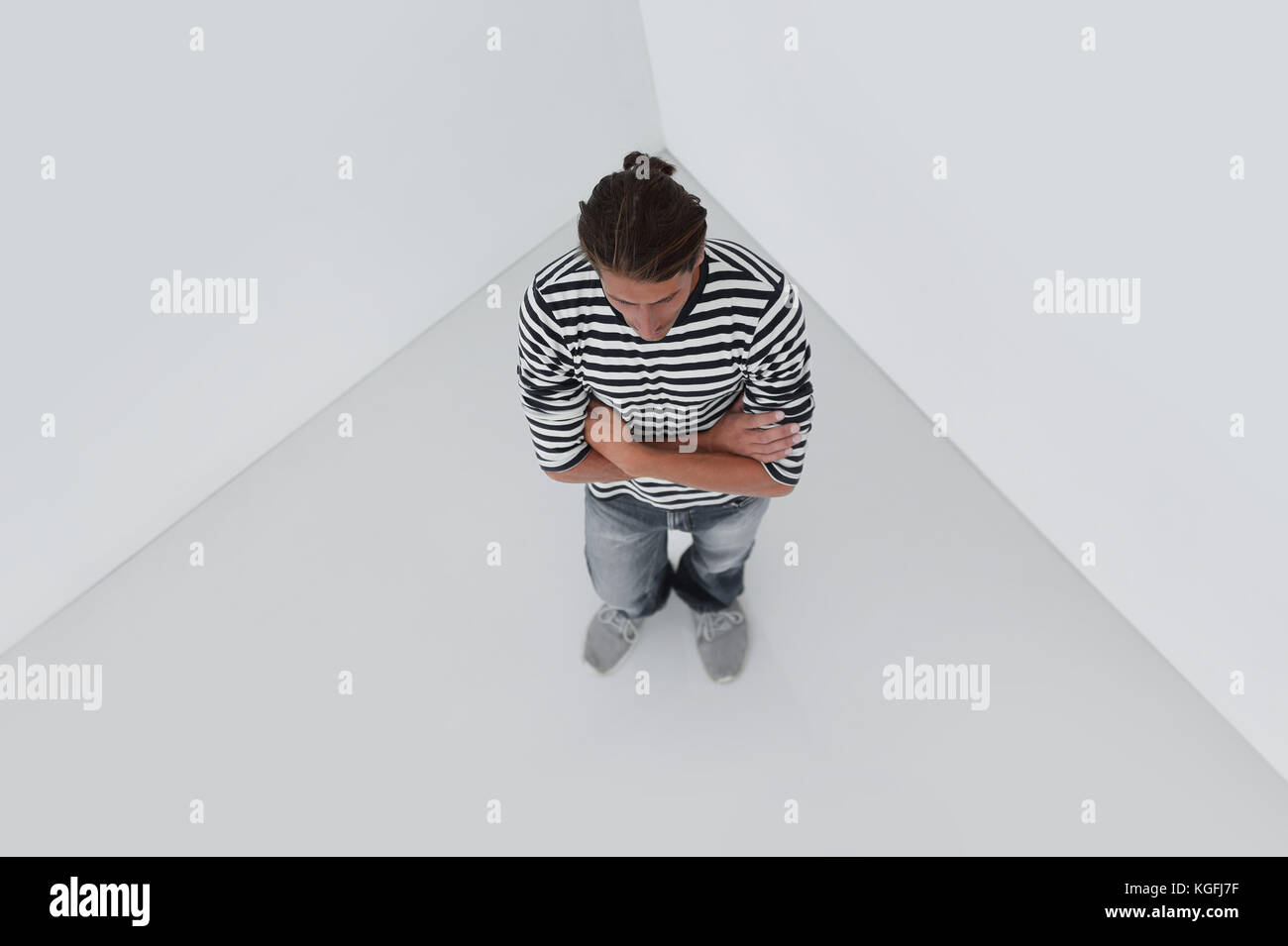 handsome guy standing near the white wall Stock Photo - Alamy