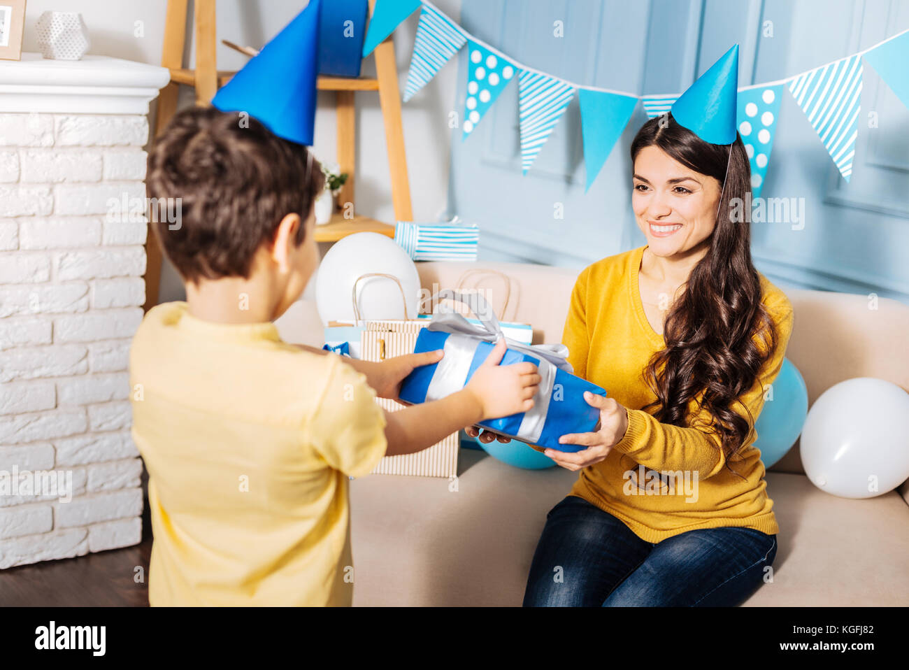 Little boy giving birthday present to his mother Stock Photo - Alamy