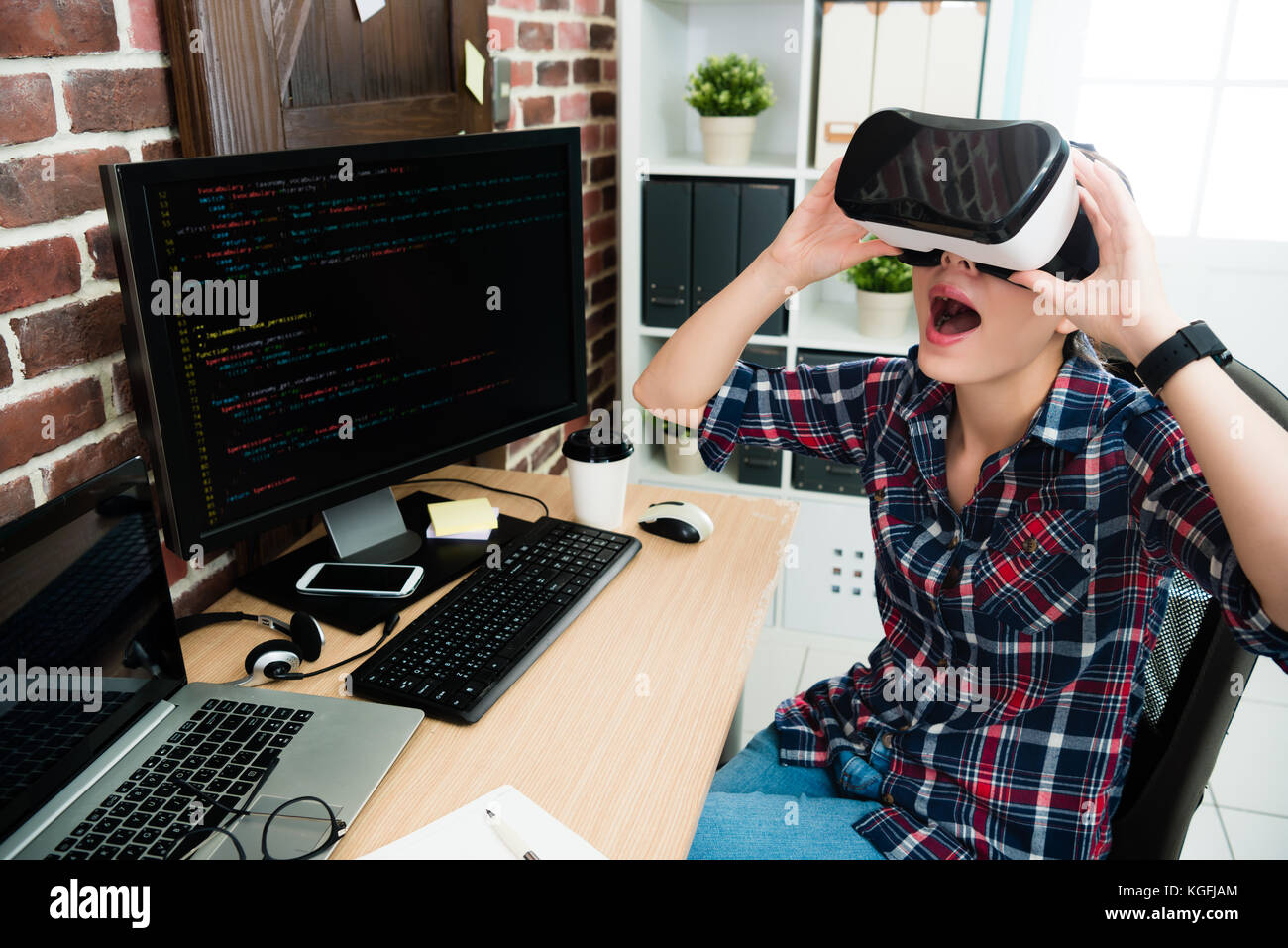 beautiful happy programmer woman using virtual reality goggles watching ...