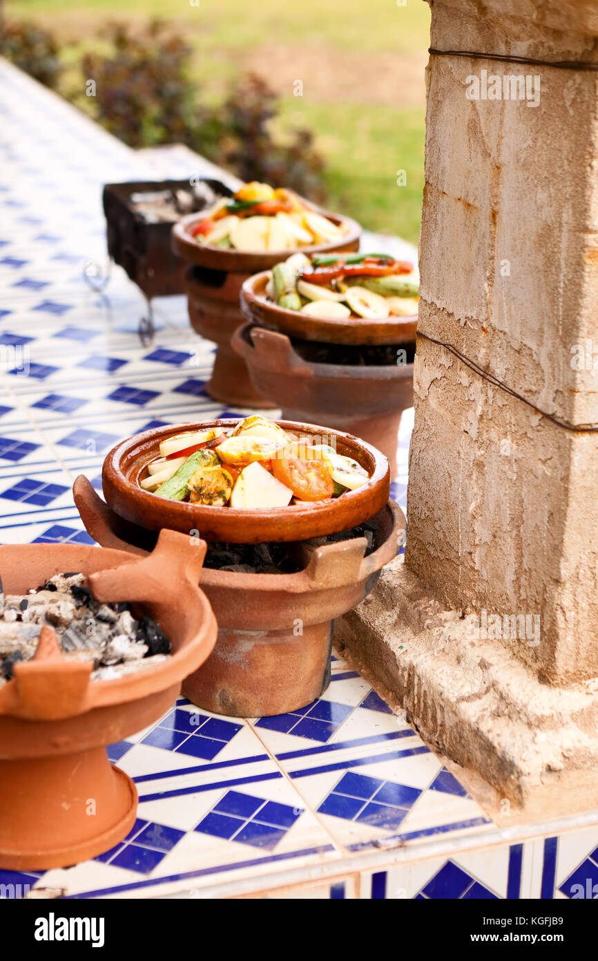 tajine ceramic cookware slow cooking over wood charcoal at outdoor ...