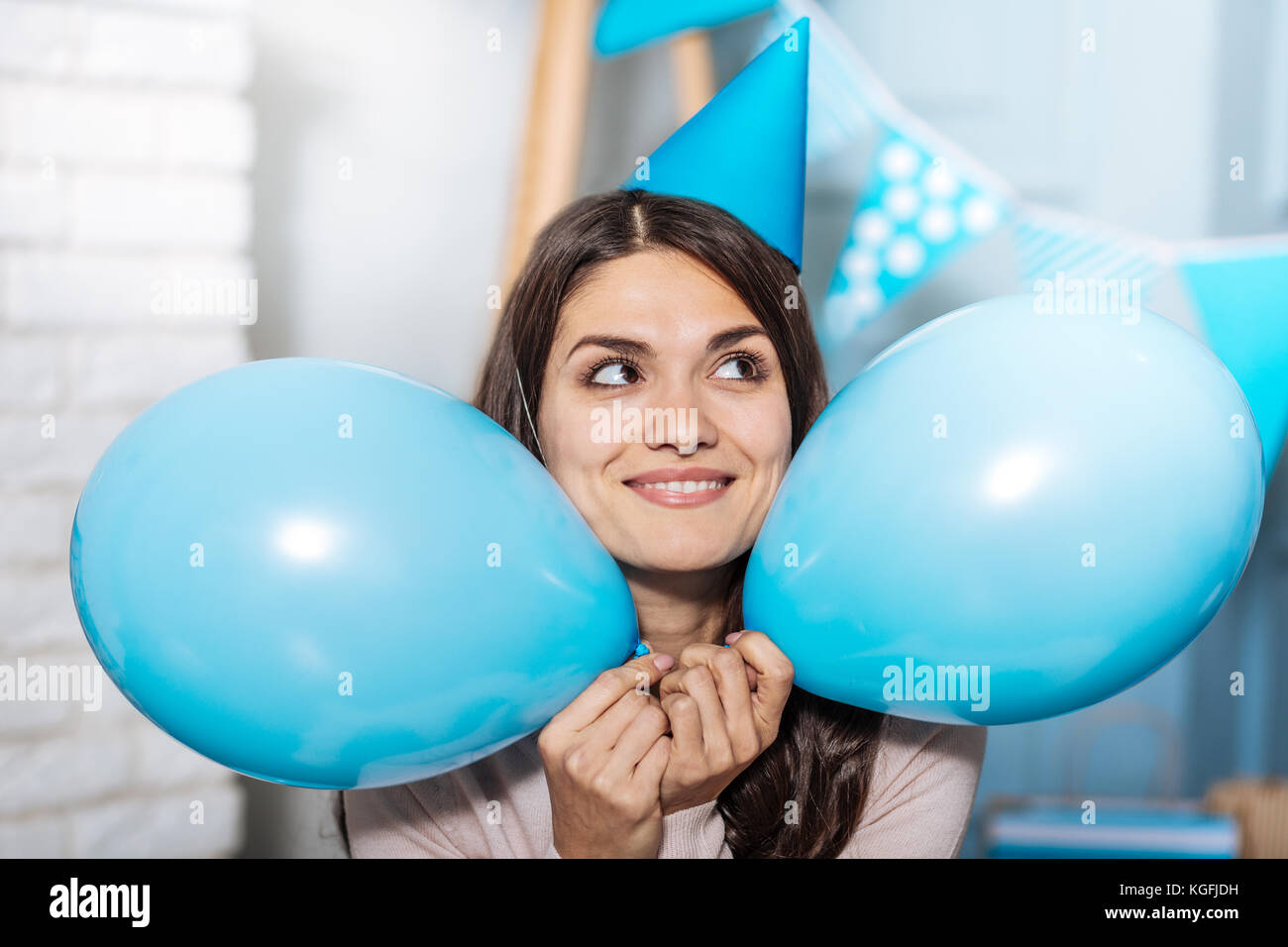 Happy woman holding two balloons near her face Stock Photo - Alamy