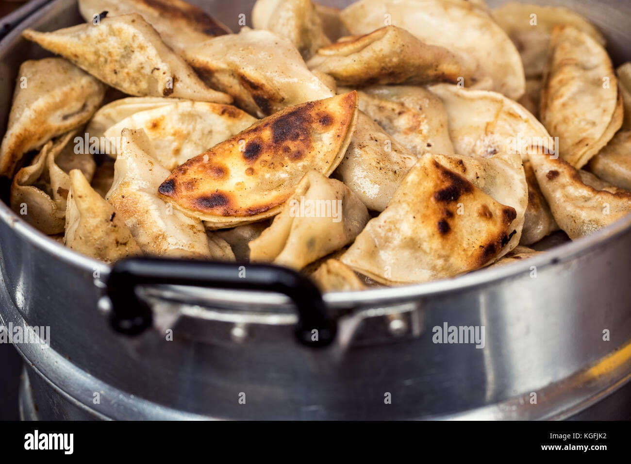 Filled fried dumplings, food market display Stock Photo - Alamy