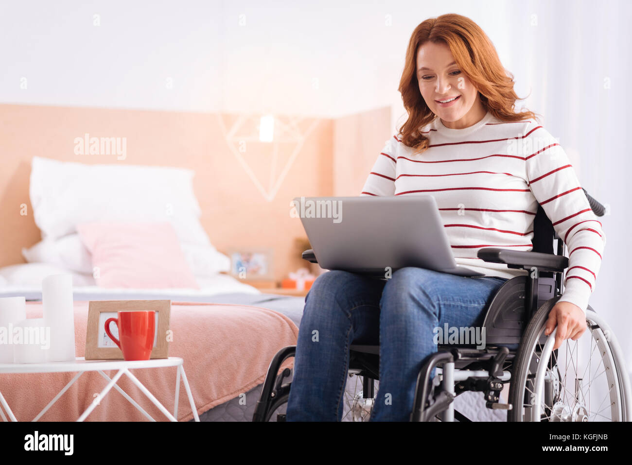 Smiling incapacitated woman working on her laptop Stock Photo - Alamy
