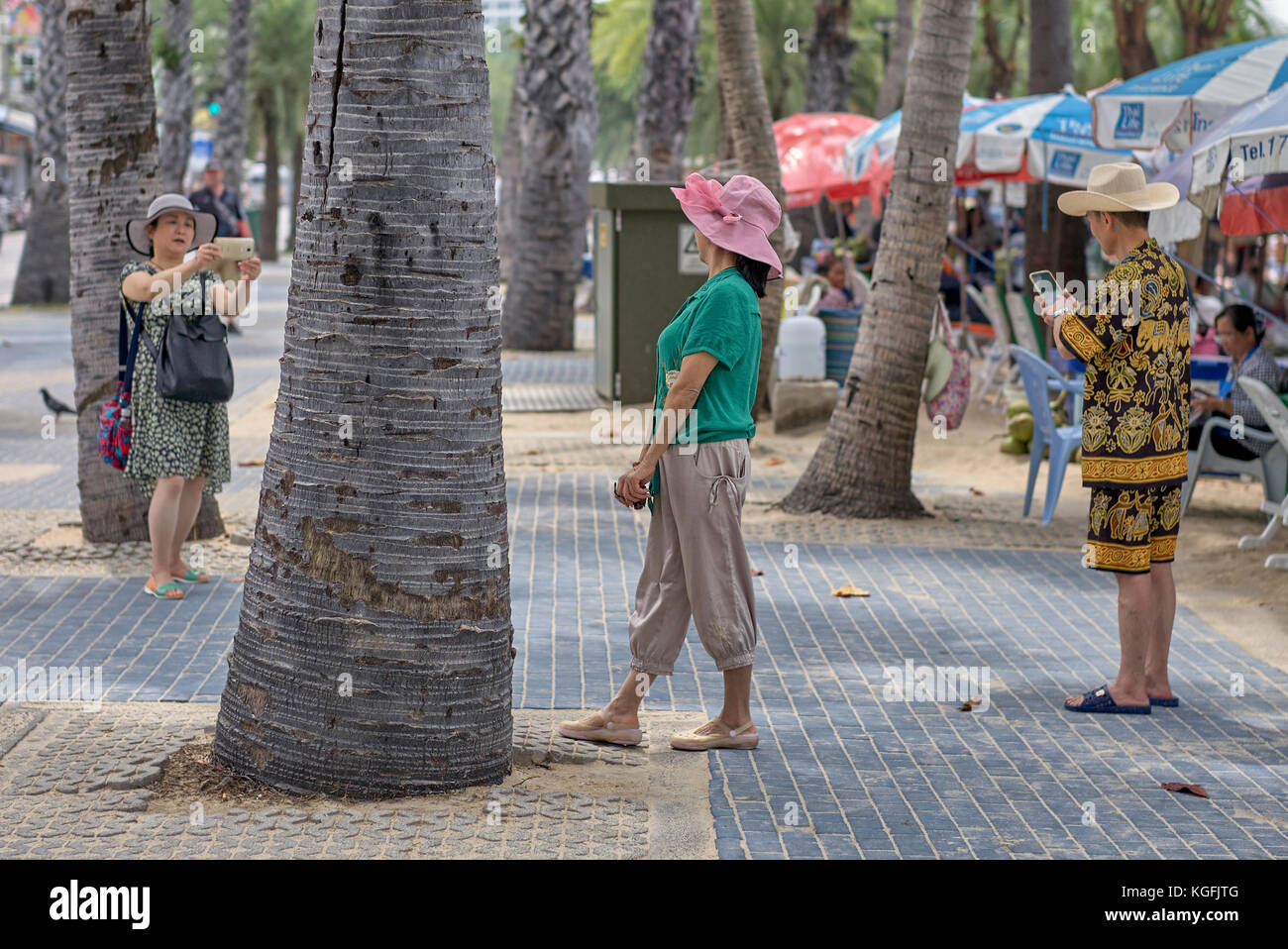 Woman taking photograph of female friend. Chinese people. Tourists ...