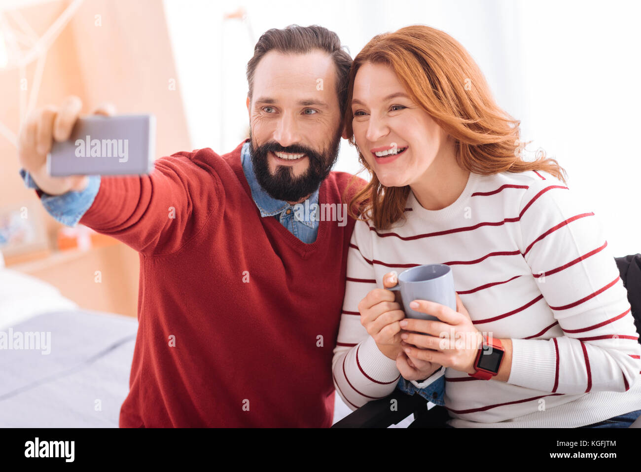 Exuberant man and handicapped woman taking pictures Stock Photo - Alamy
