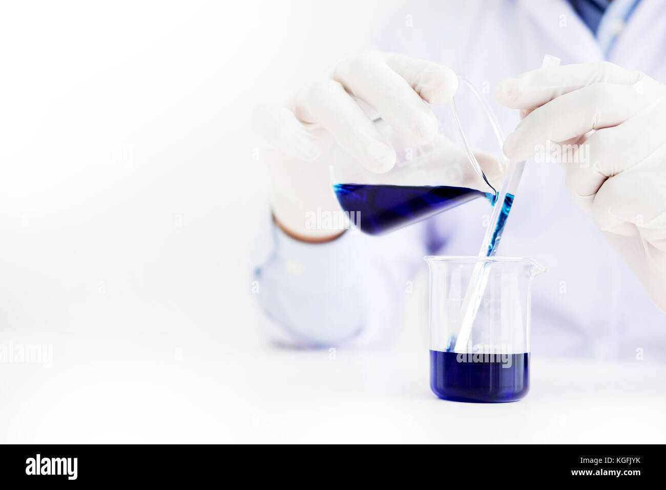 scientists and scientific equipment Pouring mixing reagents liqiud ...