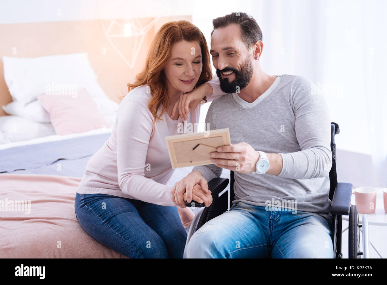 Alert woman and crippled man looking at the photo Stock Photo - Alamy