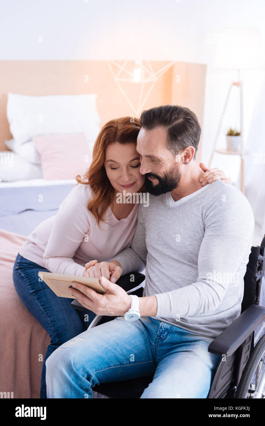 Smiling woman hugging a disabled man Stock Photo - Alamy