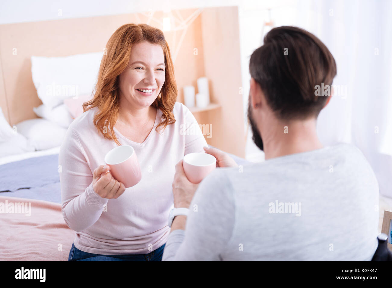 Happy woman and man having tea at home Stock Photo - Alamy