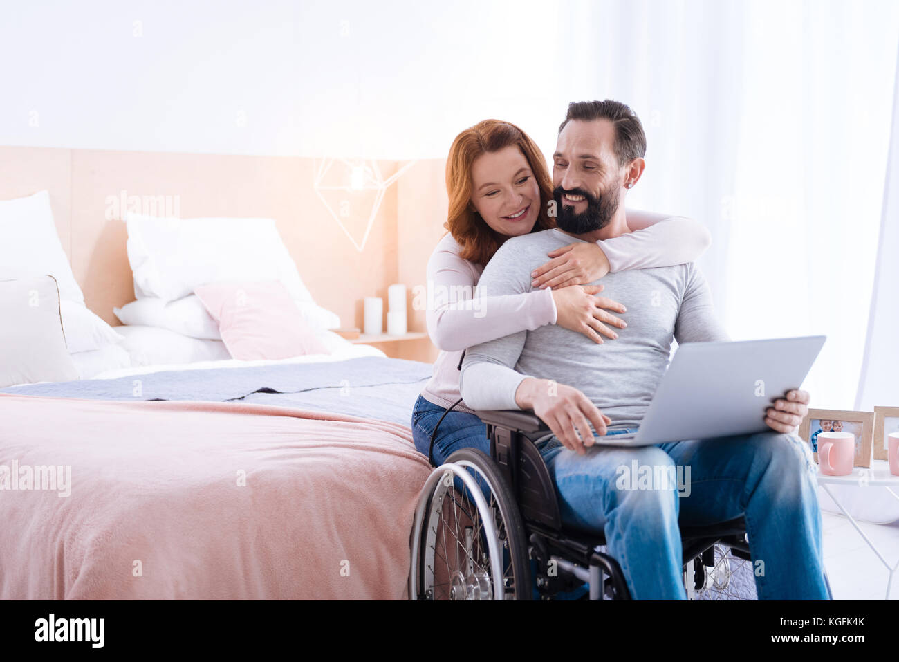 Happy woman hugging her disabled man Stock Photo - Alamy