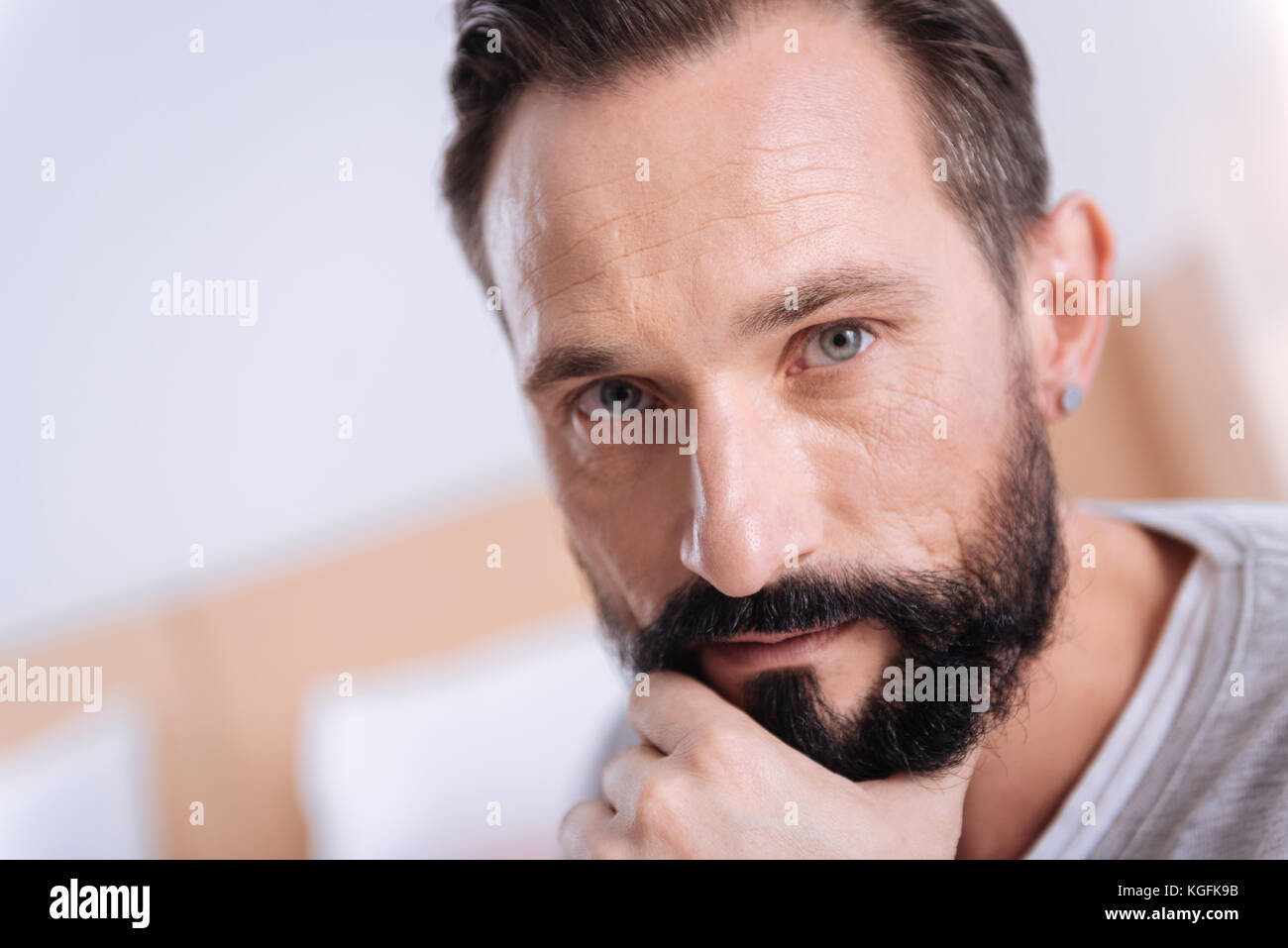 Serious dark-haired grey-eyed man thinking Stock Photo - Alamy