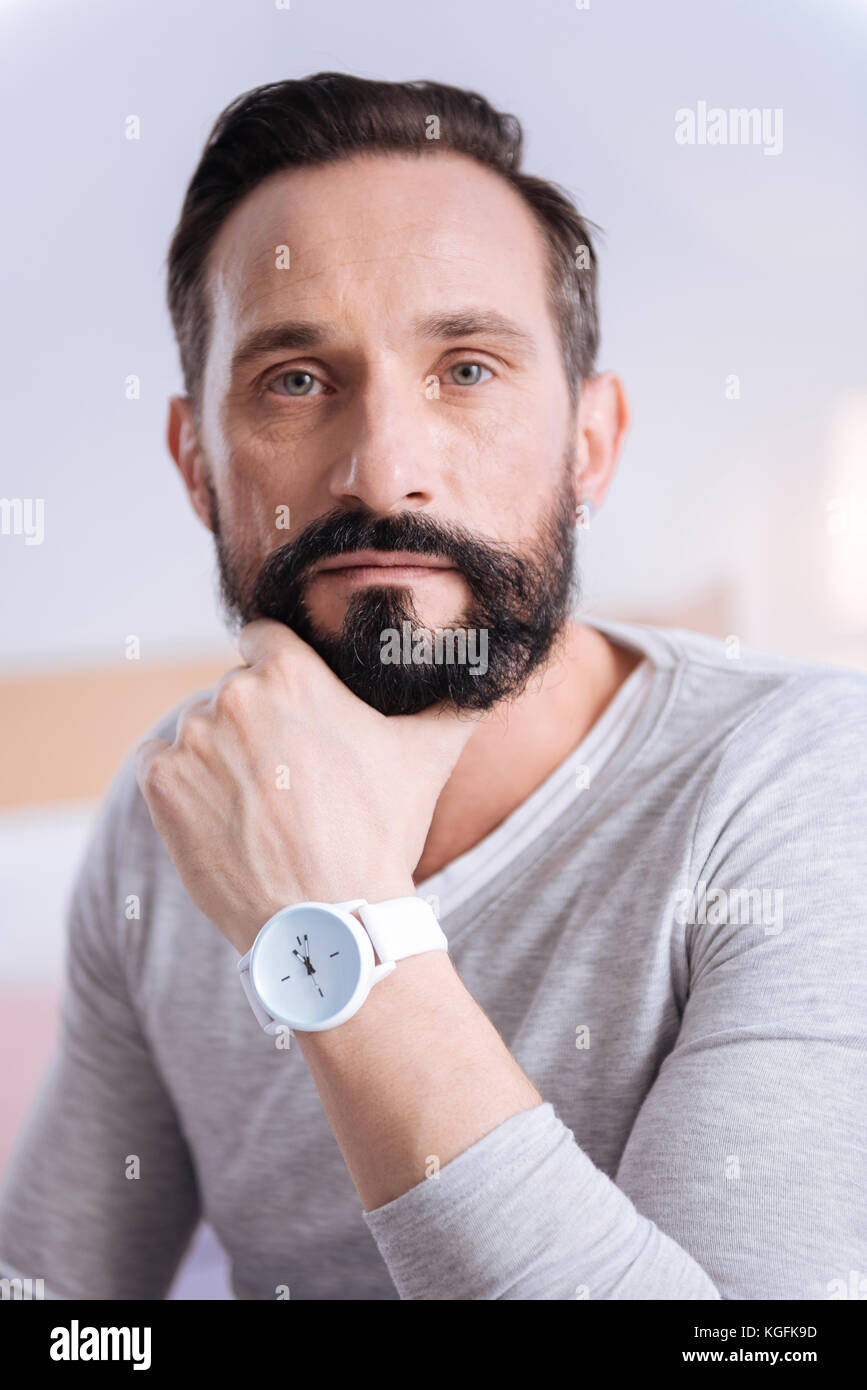 Serious handsome man touching his chin Stock Photo - Alamy