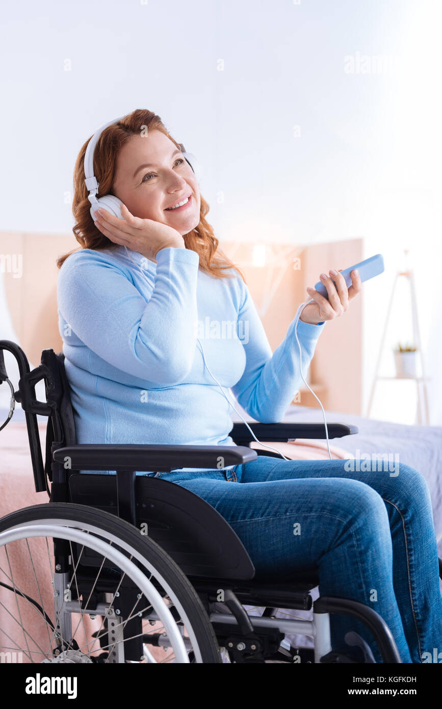 Smiling crippled woman doing her favourite activity Stock Photo - Alamy
