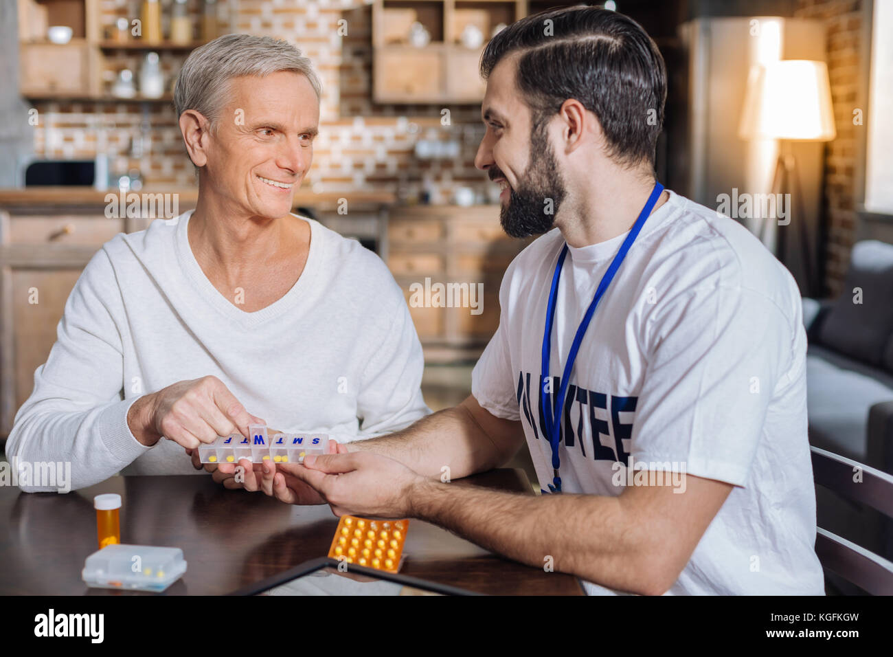 Happy senior man taking a pill from a new pill box Stock Photo - Alamy