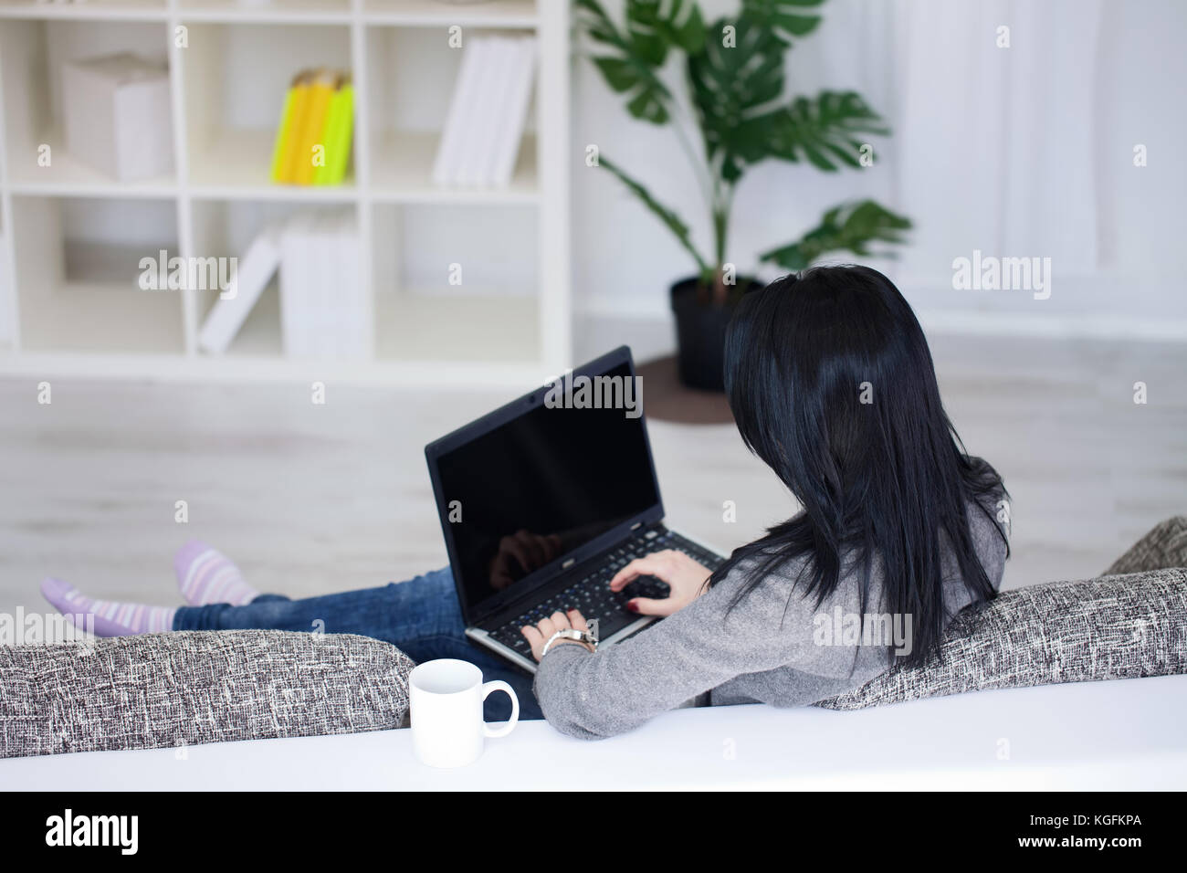 young girl with laptop computer, back view Stock Photo - Alamy