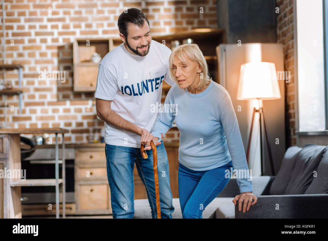 Sad elderly woman getting help from her social worker Stock Photo - Alamy
