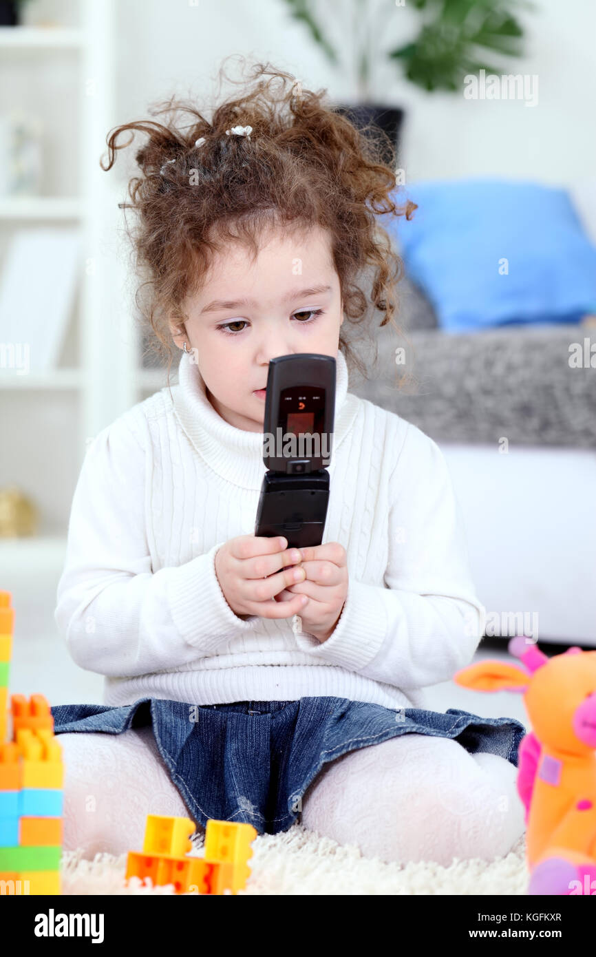 little girl is playing in java game on mobile phone Stock Photo - Alamy