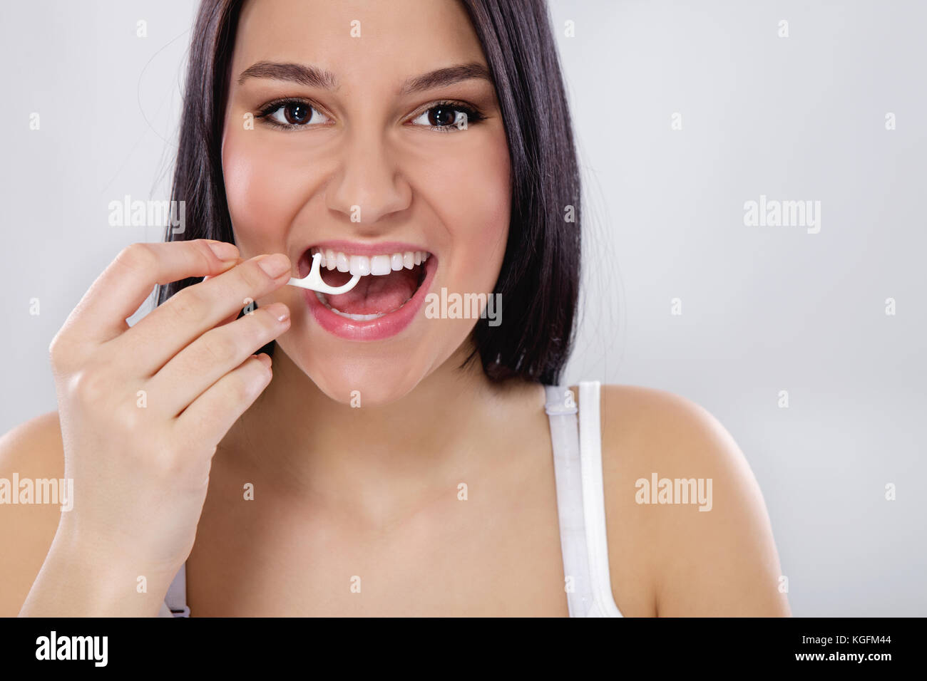 cute girl cleaning her teeth Stock Photo - Alamy