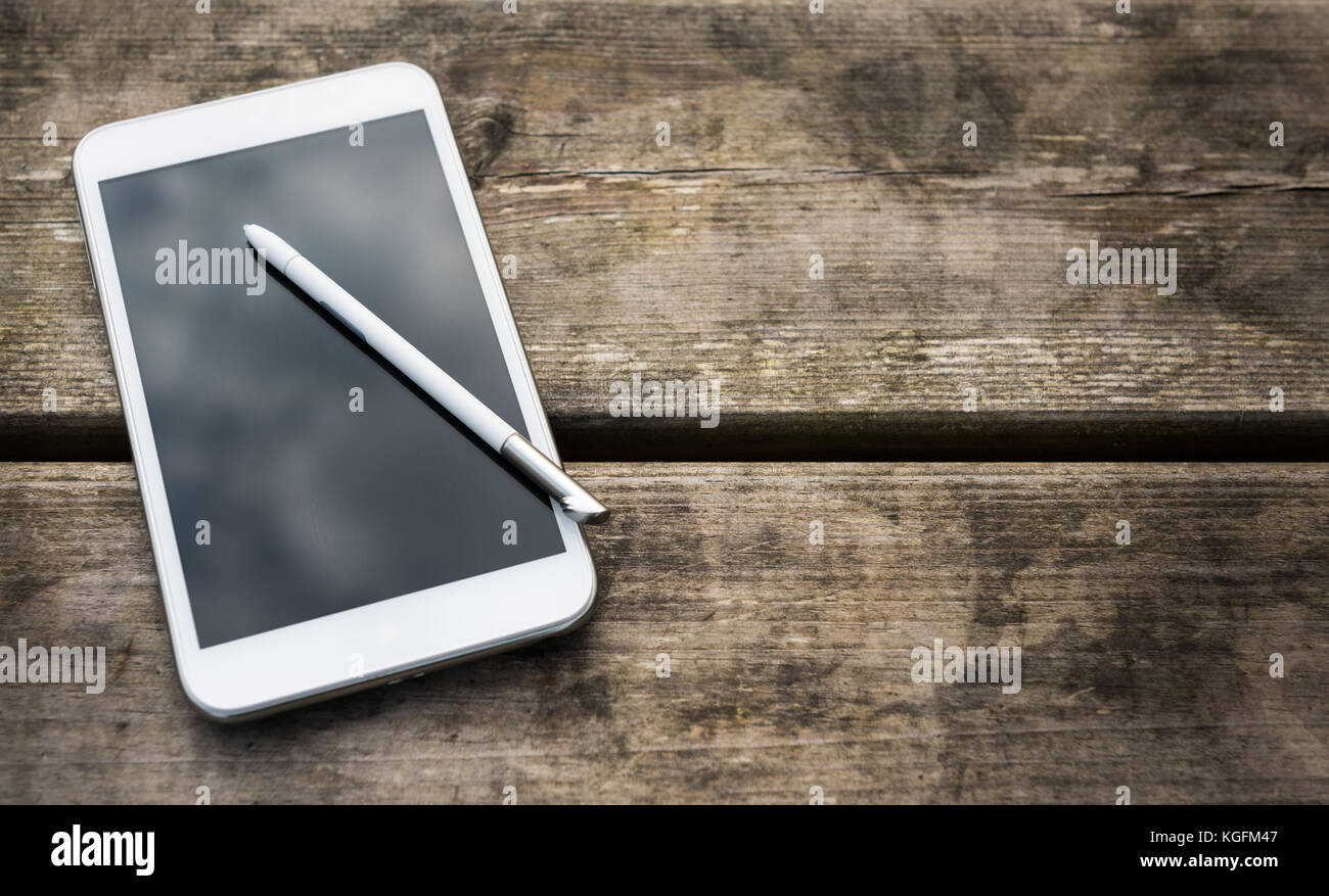 Rustic wooden table with smartphone. View from above with copy space ...