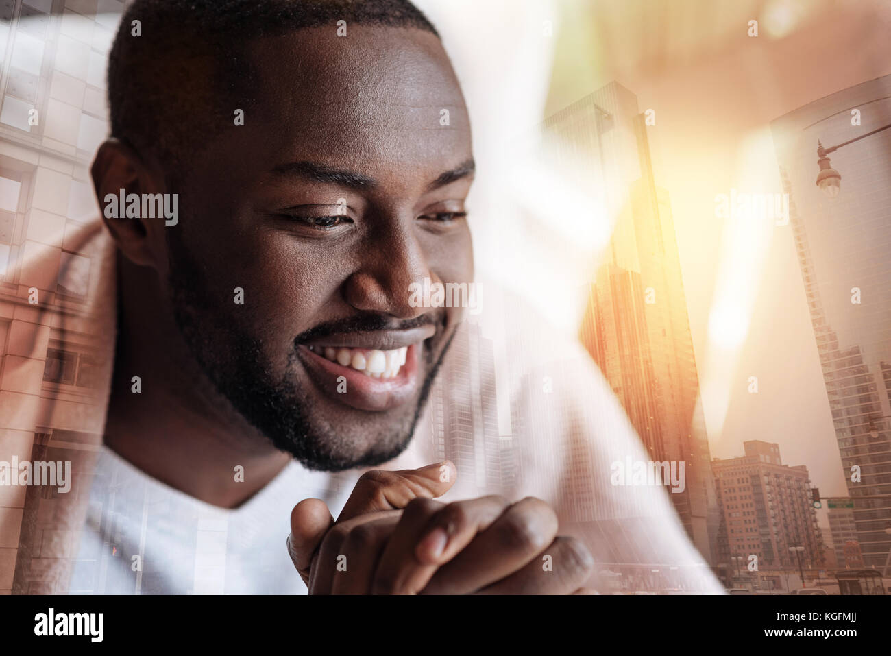 Afro-American young man smiling and thinking Stock Photo - Alamy