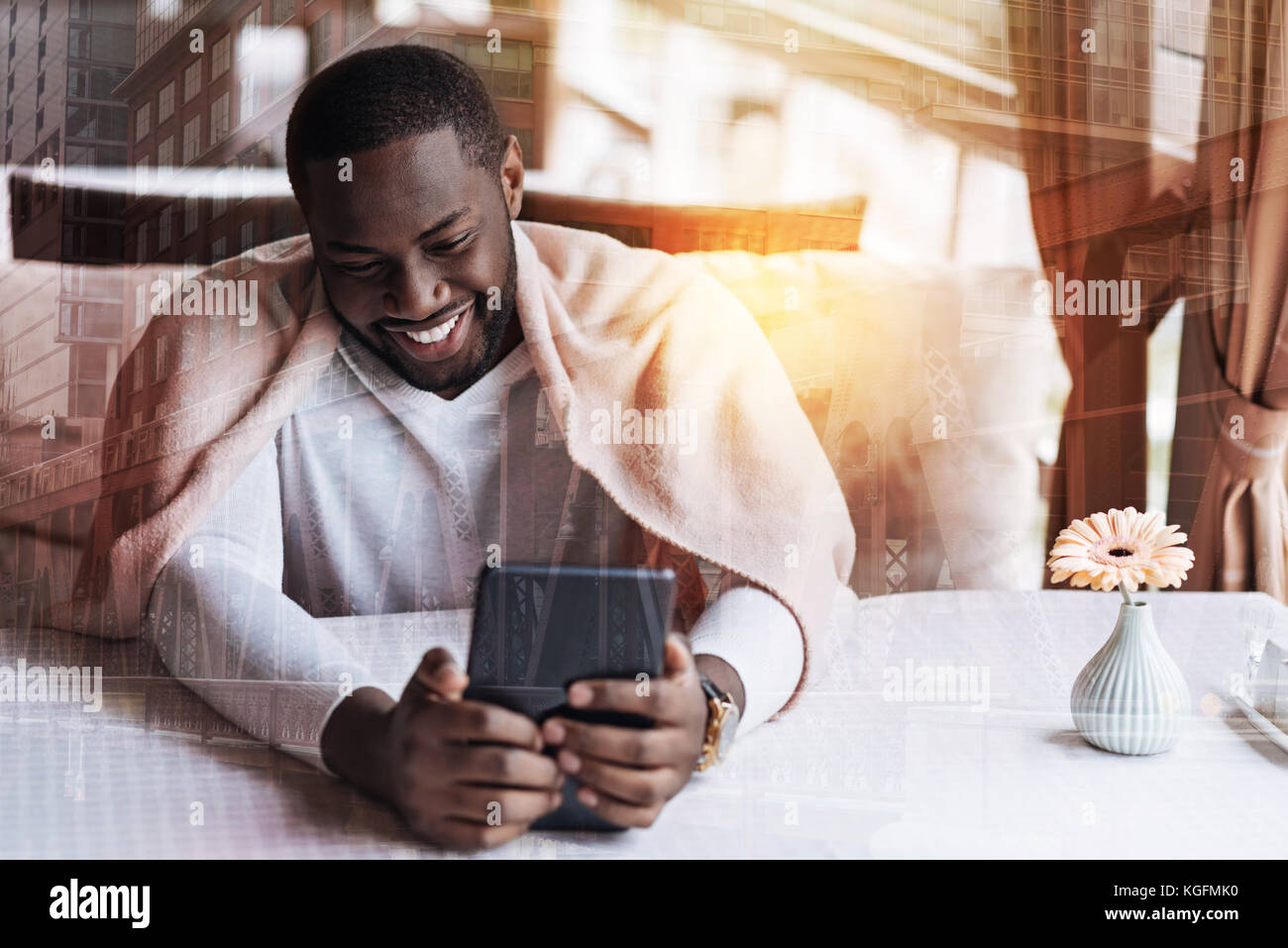 Smiling man using his phone Stock Photo - Alamy