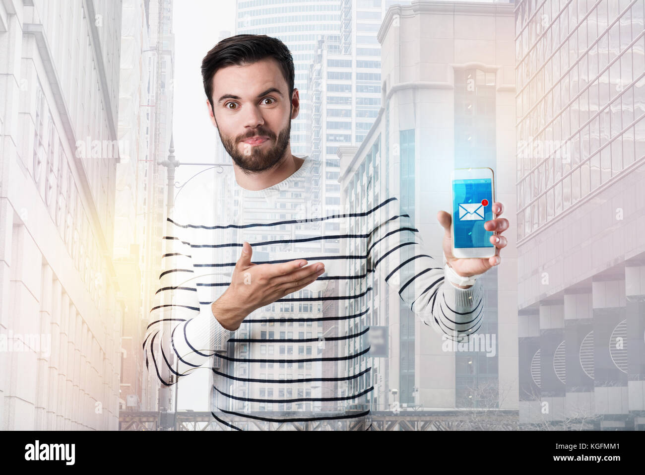 Happy young man enjoying his new gadget Stock Photo - Alamy