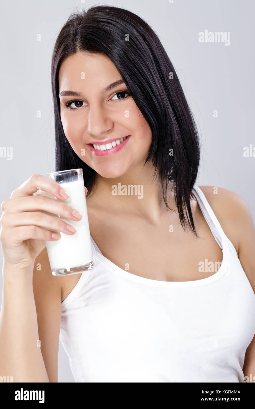 Milk - Woman drinking milk, happy and smiling beautiful young woman ...