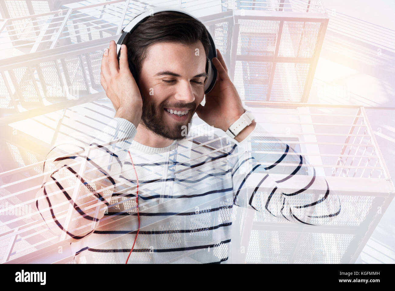 Happy young man enjoying the music in modern headphones Stock Photo - Alamy