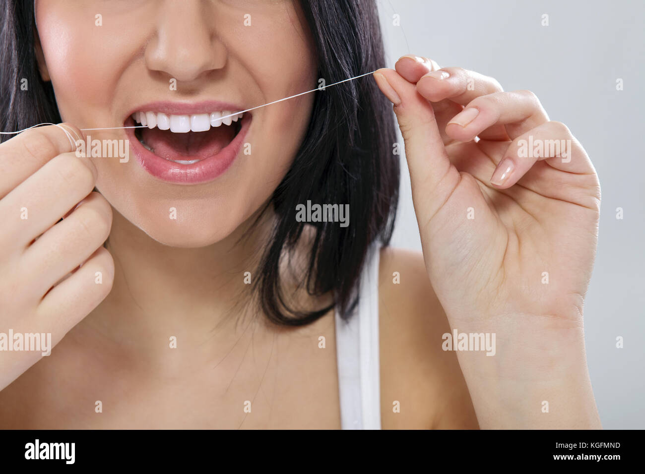 Close-up of a woman flossing his teeth with dental floss Stock Photo ...