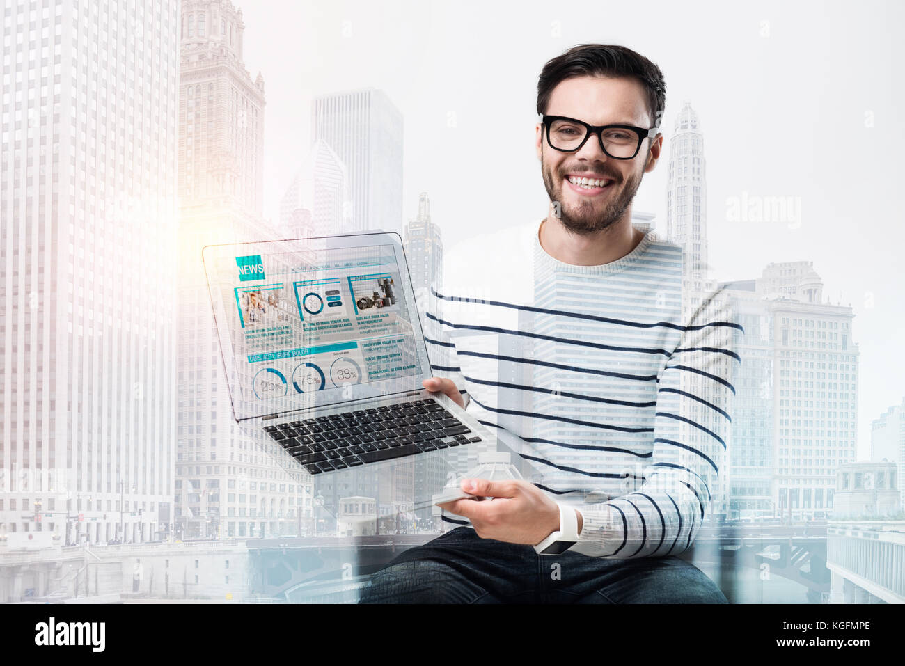 Happy cheerful man showing the screen of his laptop Stock Photo - Alamy