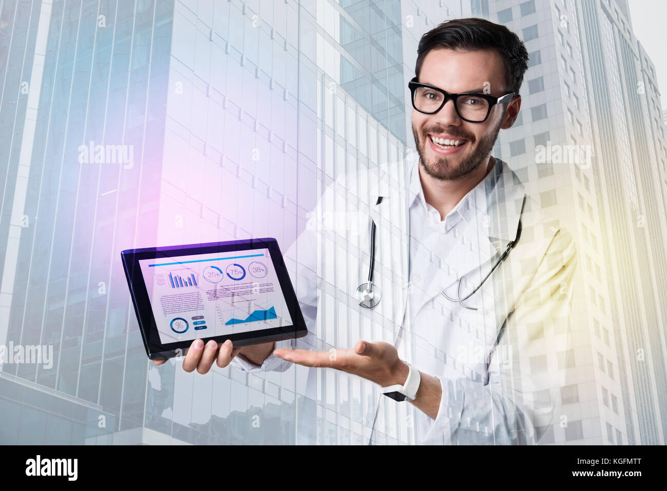 Positive smiling doctor pointing to the screen of a tablet Stock Photo ...