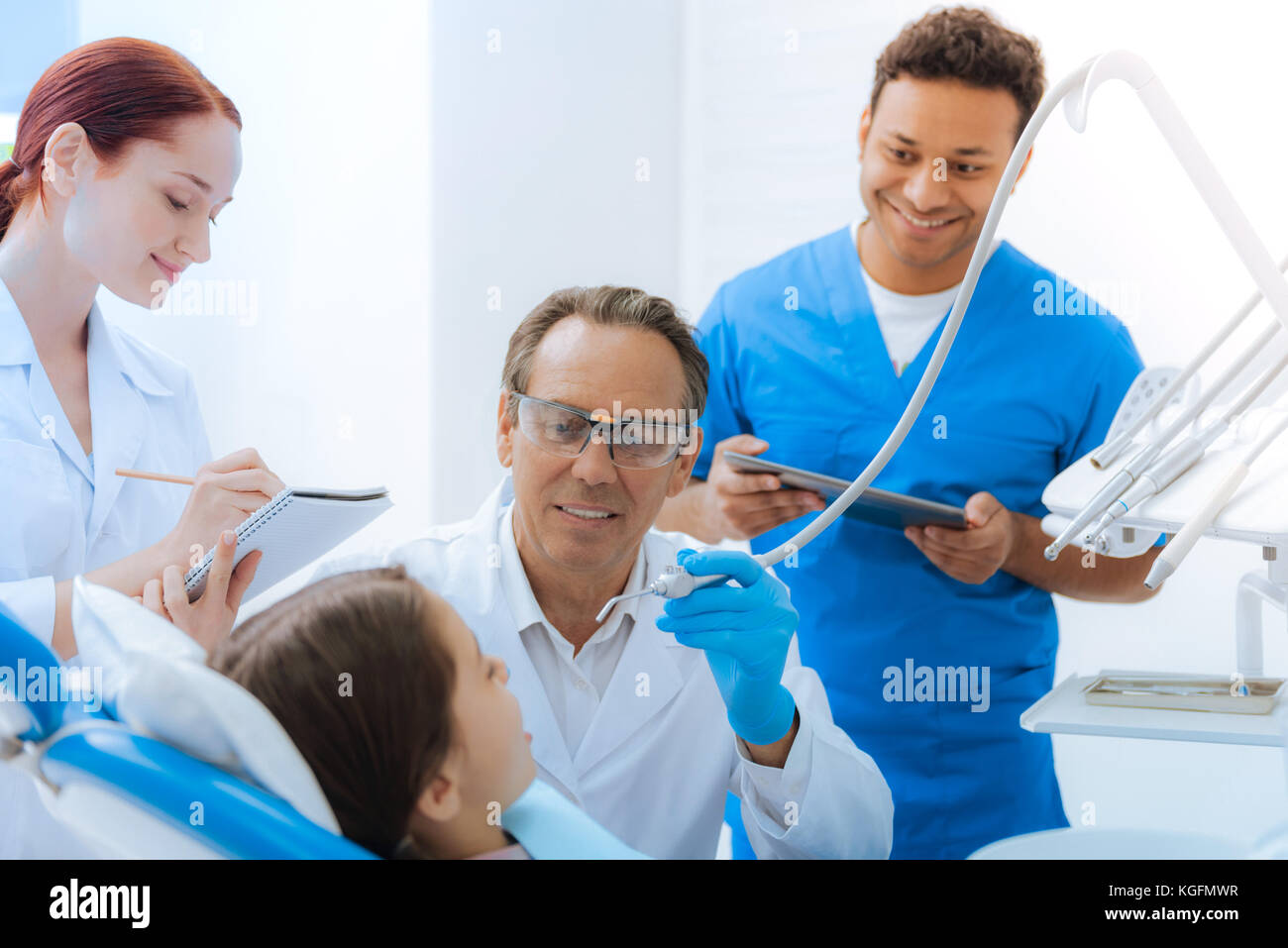 Delighted positive doctor treating his young patient Stock Photo - Alamy