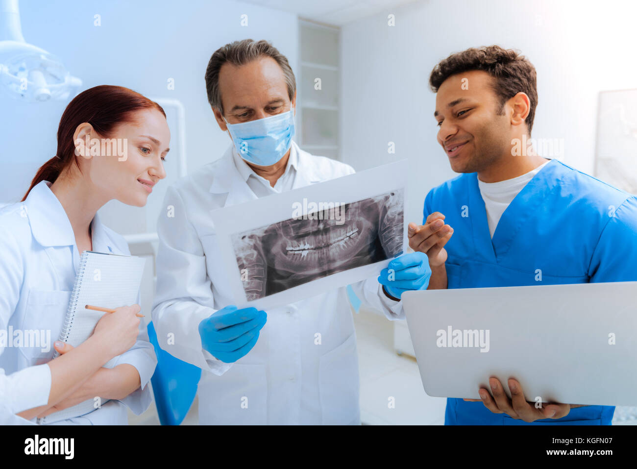 Delighted professional doctors talking to each other Stock Photo - Alamy
