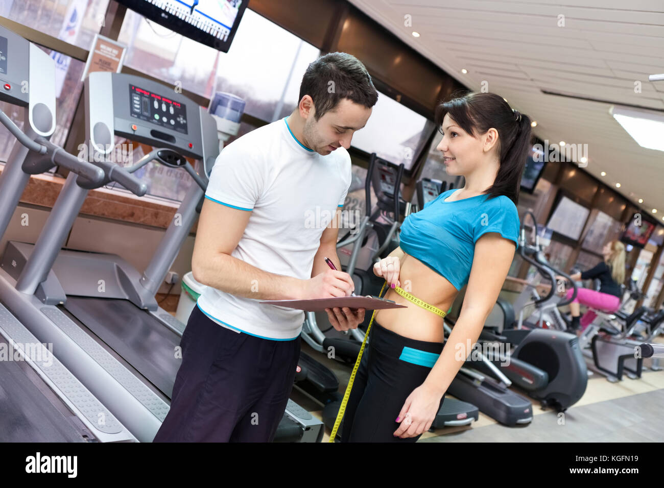 professional trainer measuring progress in training by client Stock Photo - Alamy